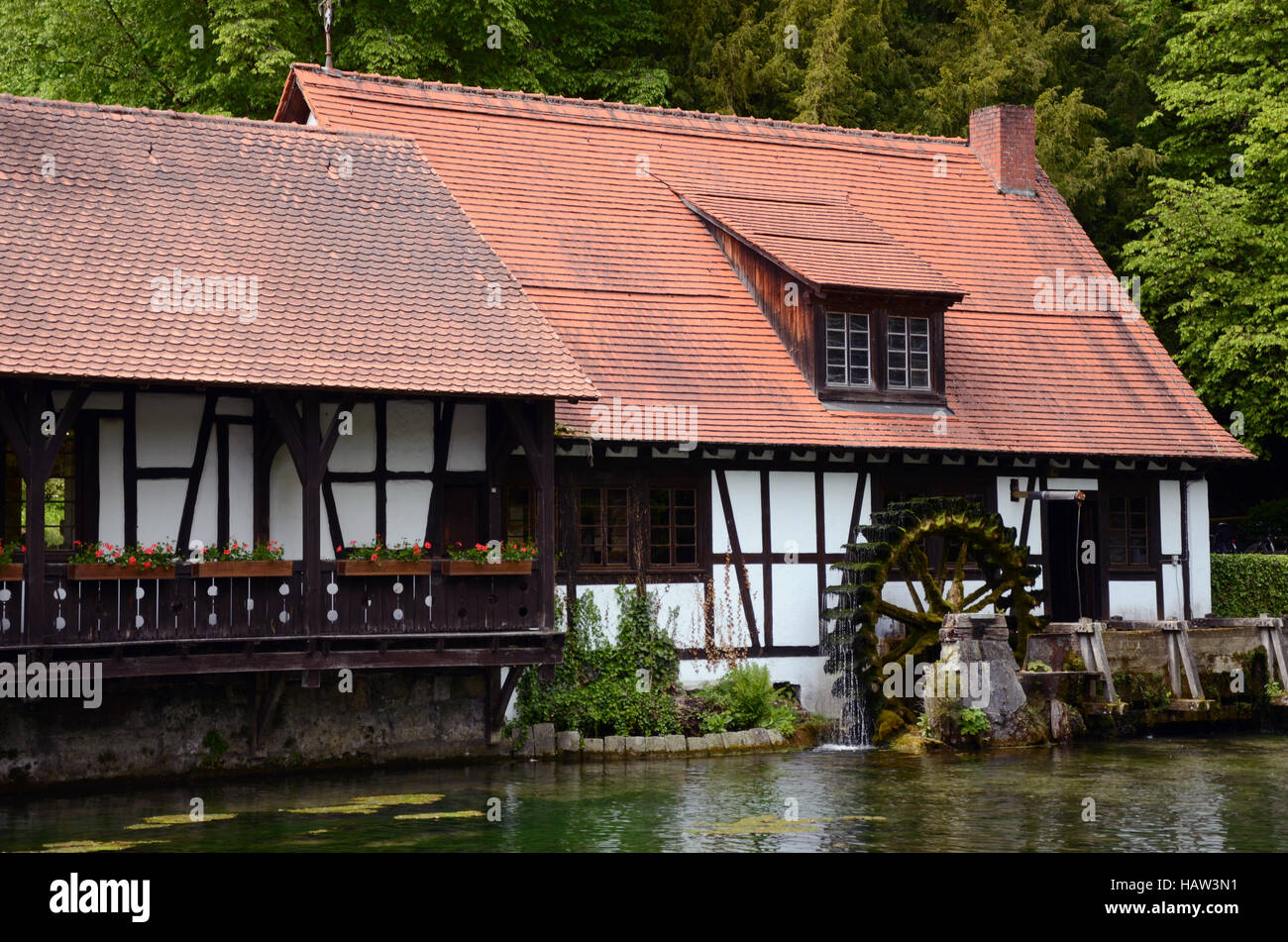 frame house with a water mill Stock Photo - Alamy