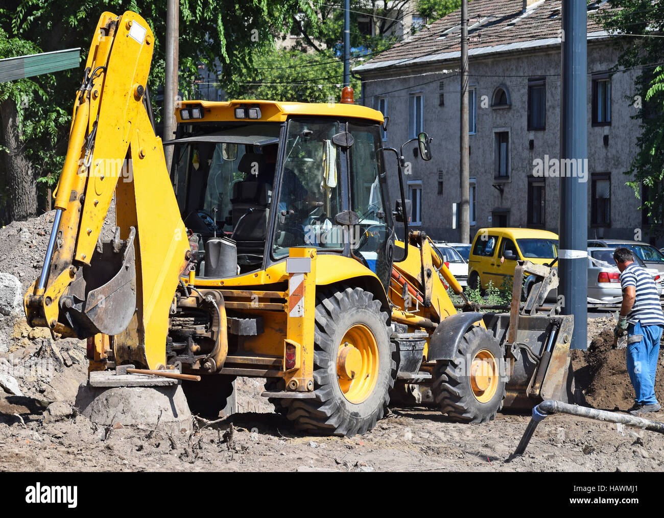 Excavator works at the road construction Stock Photo - Alamy