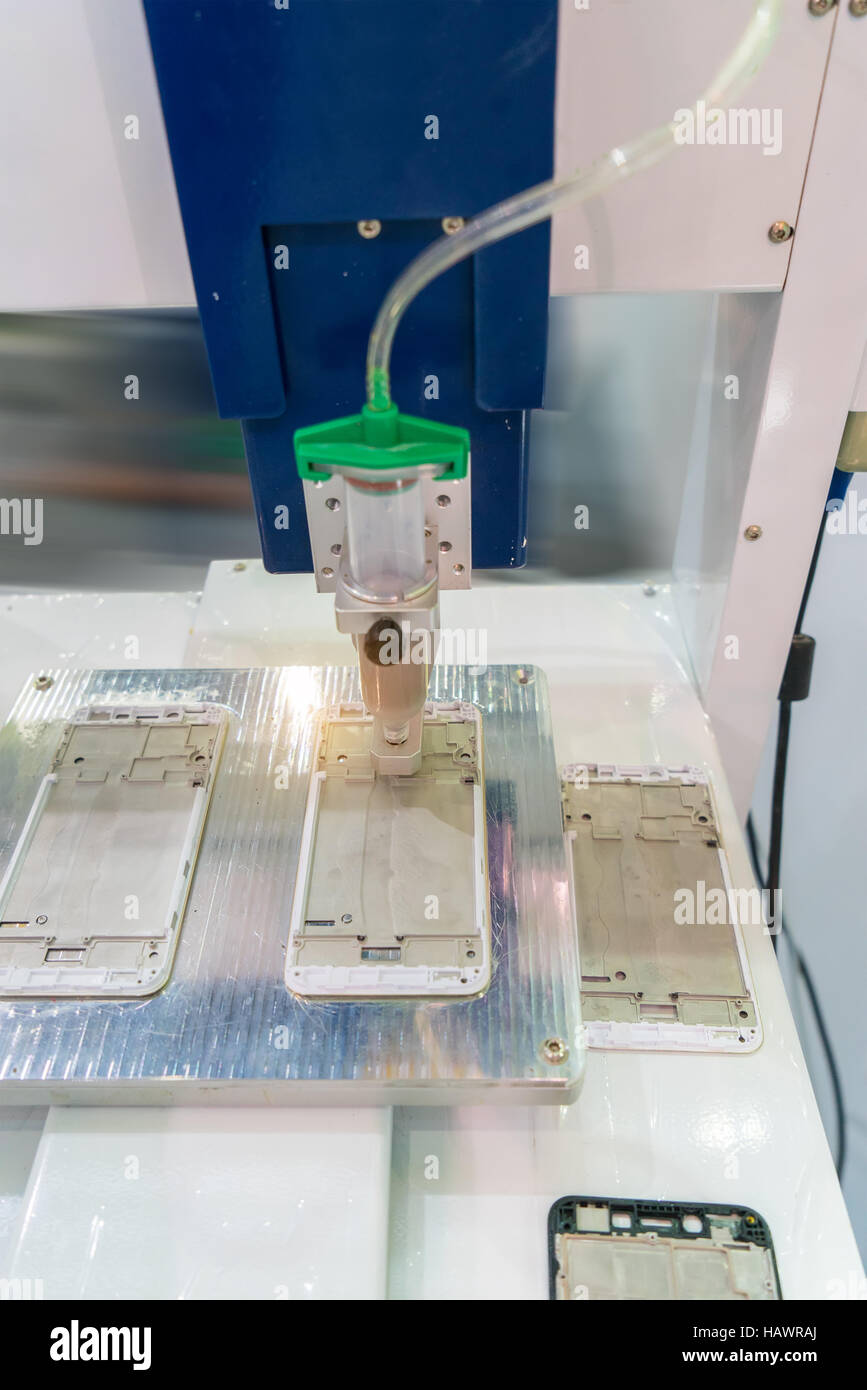 Robot holding glue syringe Injection on phone Stock Photo - Alamy