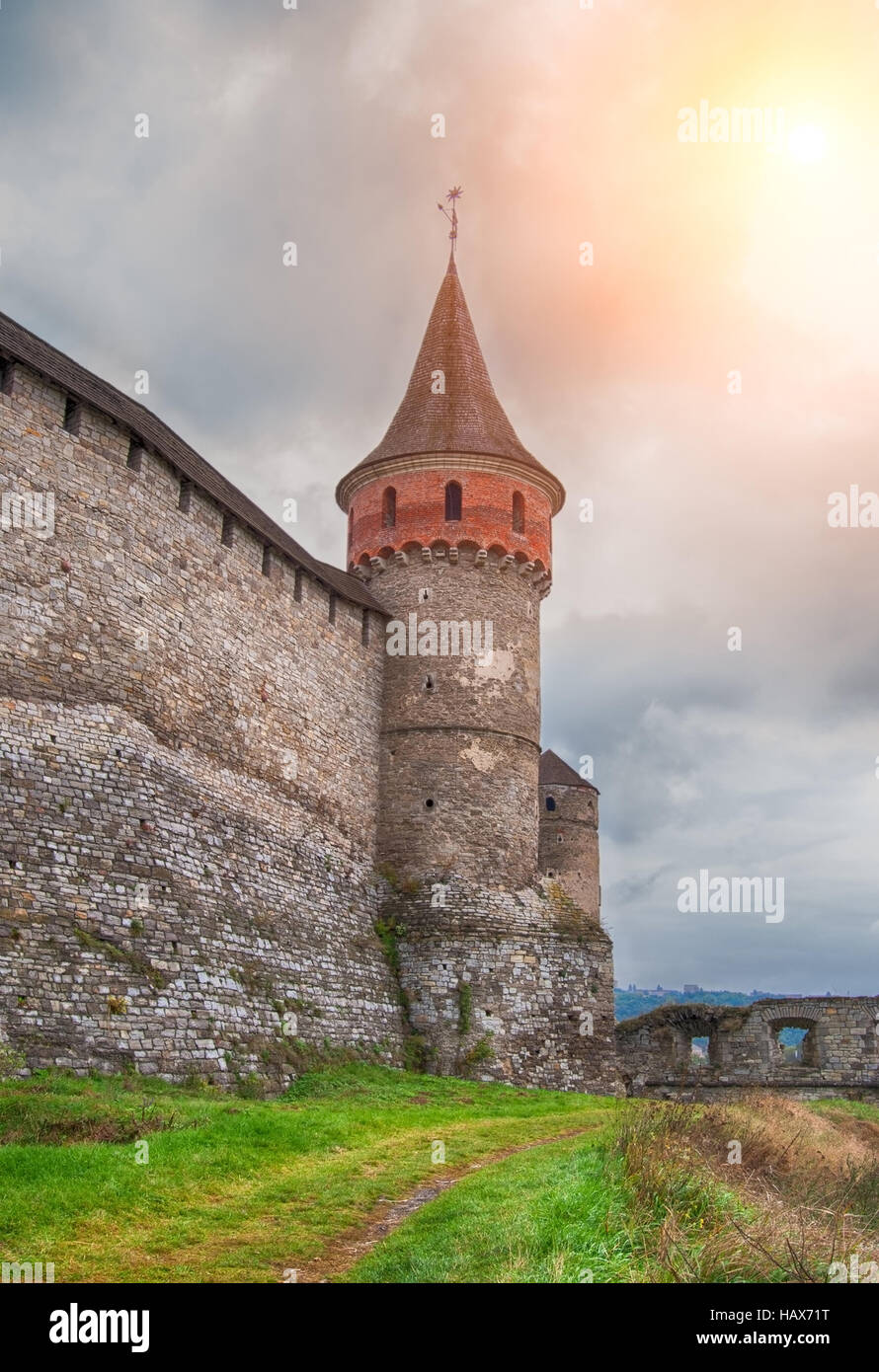 sunset over the tower of medieval half-ruined castle in Kamenetz ...