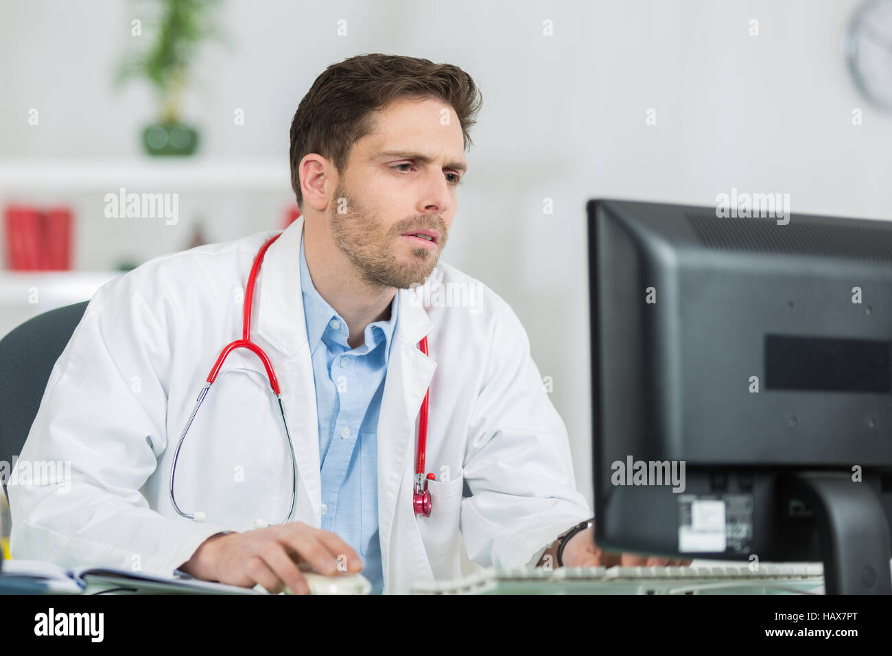 serious male doctor using computer at medical office Stock Photo - Alamy serious male doctor using computer at medical office Stock Photo - Alamy