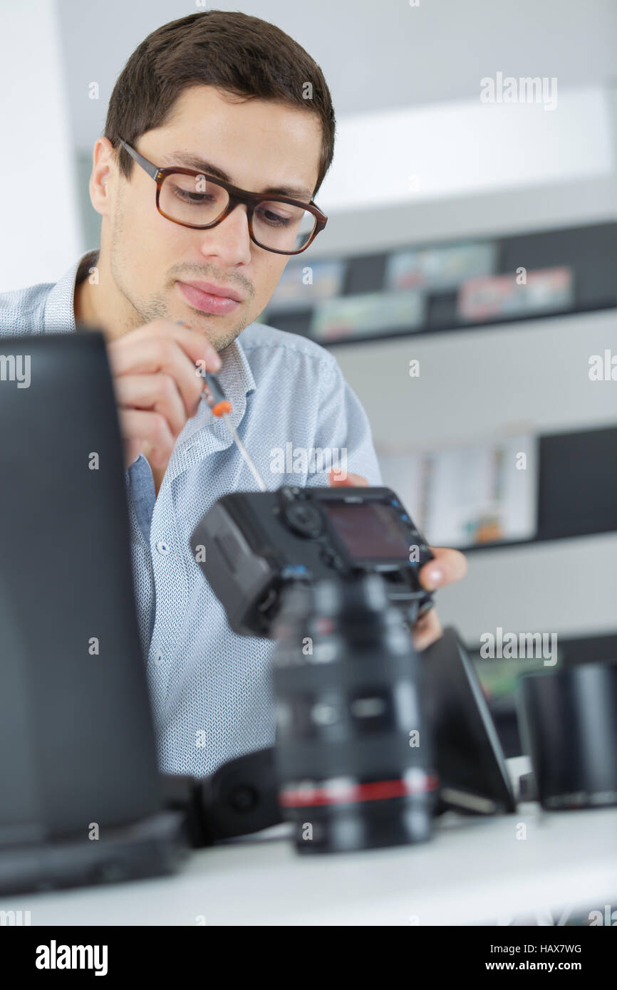 man repairs camera in workshop Stock Photo - Alamy