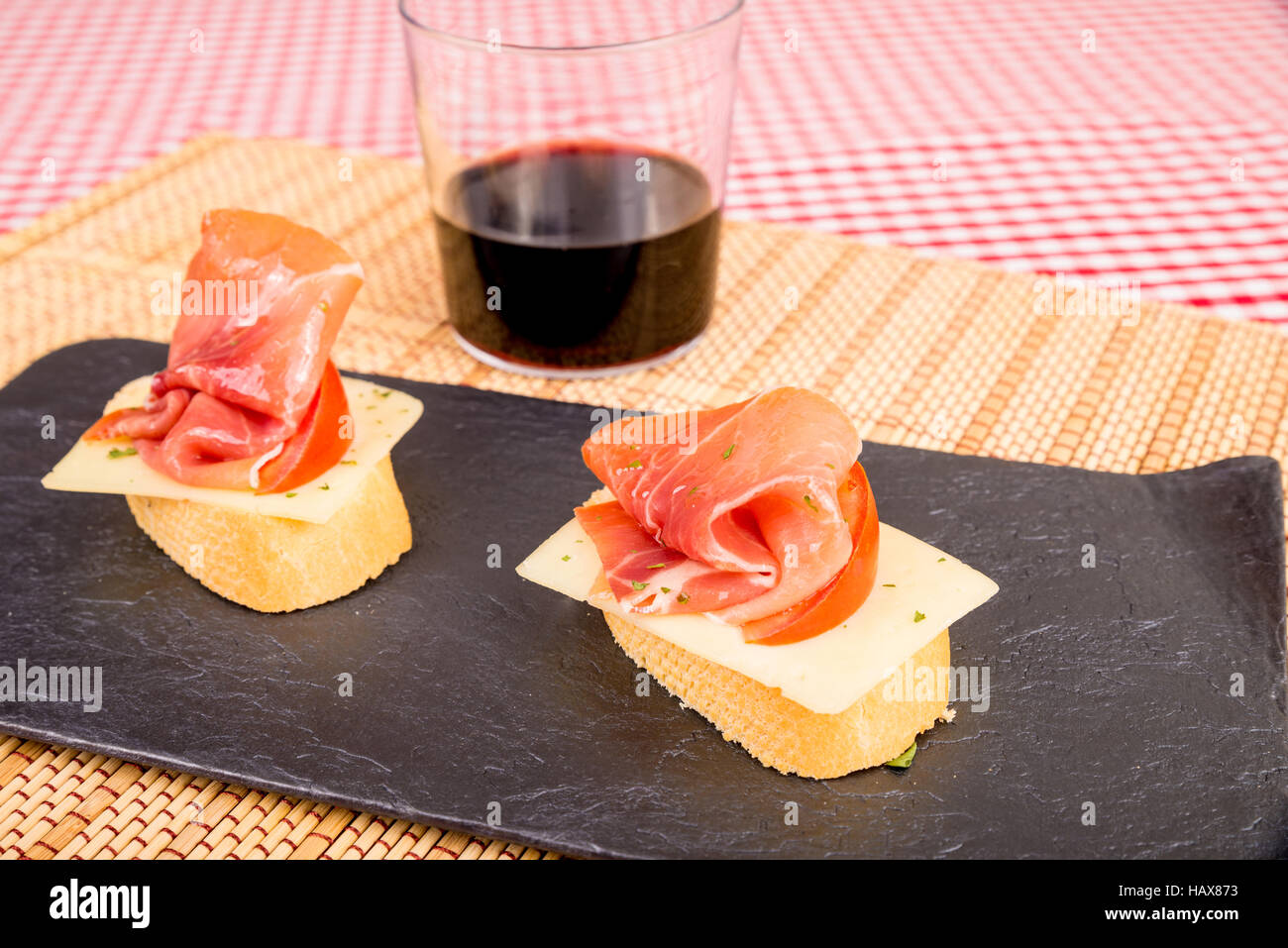 Traditional Spanish pincho style serrano ham tapa Stock Photo - Alamy