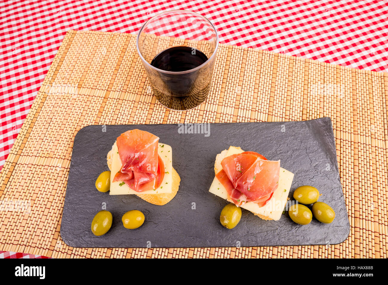 Traditional Spanish pincho style serrano ham tapa Stock Photo - Alamy
