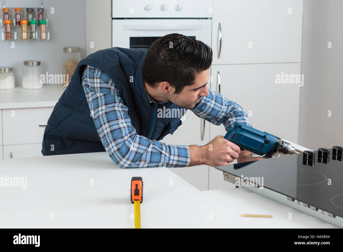 Man using power tool in residential setting Stock Photo - Alamy