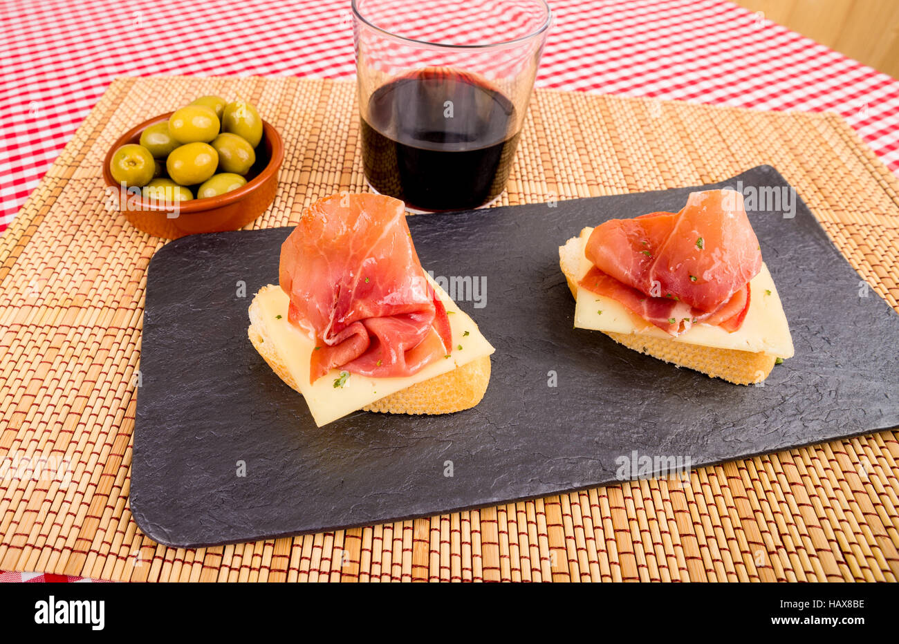 Traditional Spanish pincho style serrano ham tapa Stock Photo - Alamy