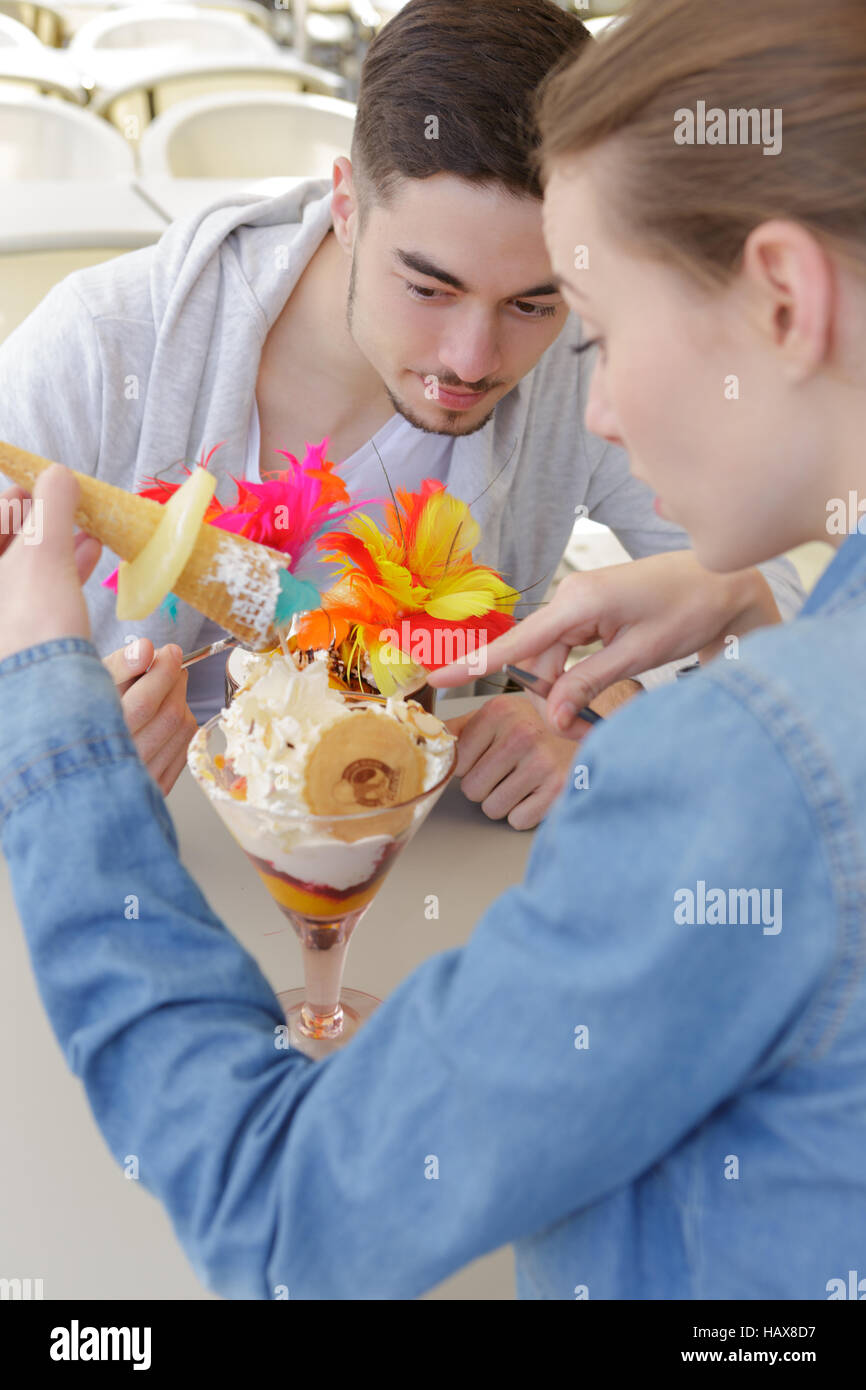 cute young beautiful teen couple sharing an ice cream Stock Photo - Alamy