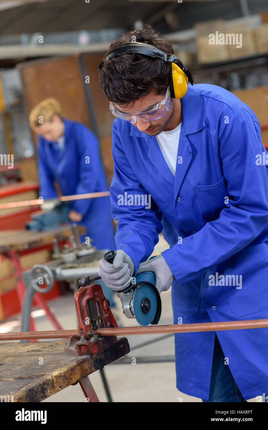 apprentice using circular saw in metallurgy workshop Stock Photo - Alamy