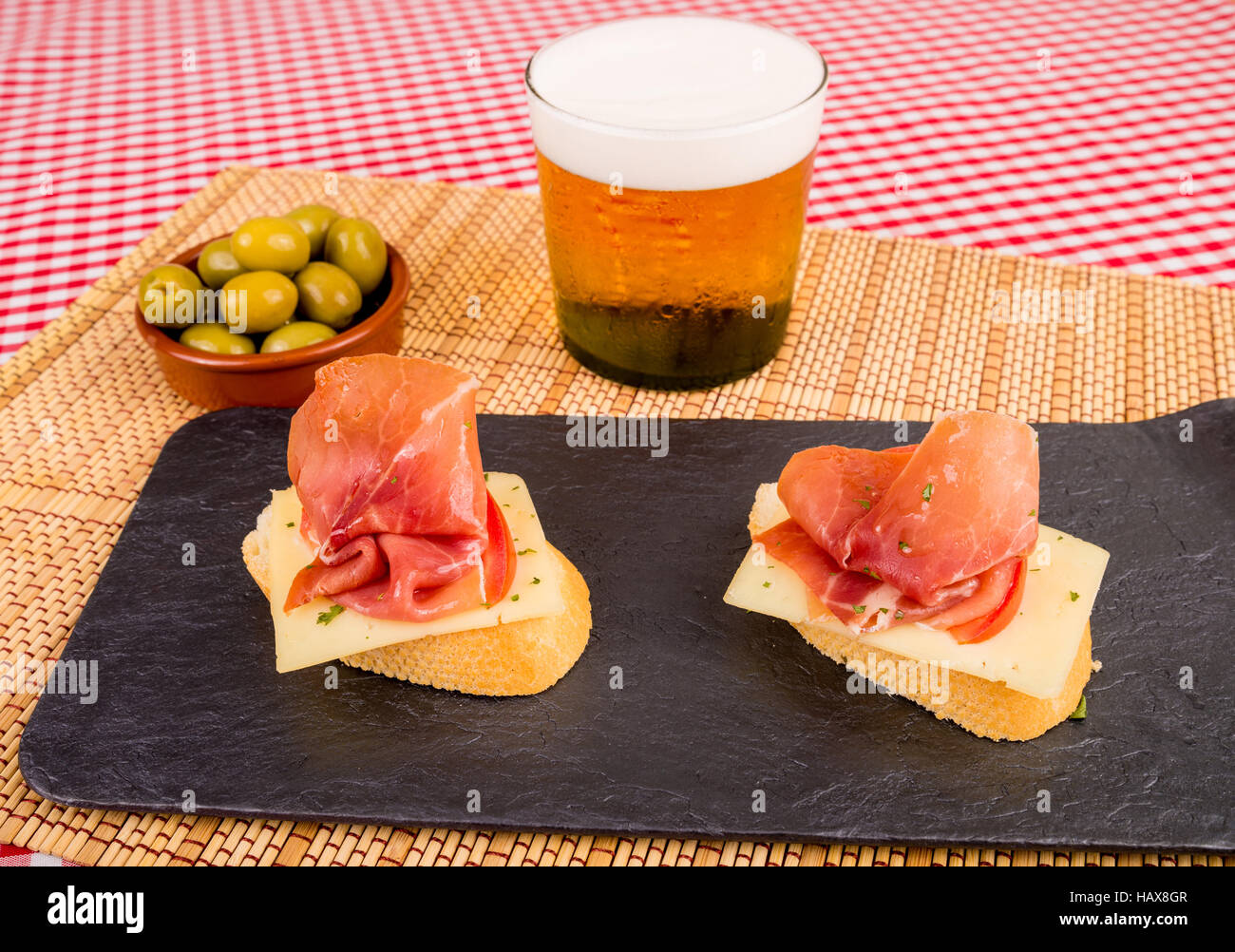 Traditional Spanish pincho style serrano ham tapa Stock Photo - Alamy