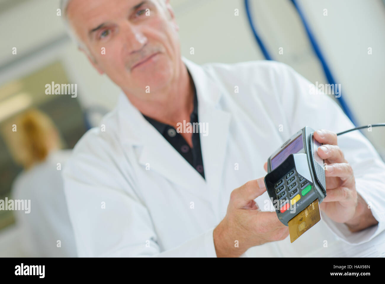 Worker holding card payment machine Stock Photo - Alamy