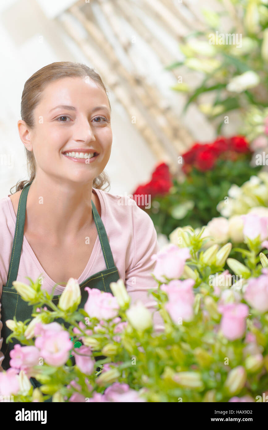 Portrait of attractive smiling female florist Stock Photo - Alamy