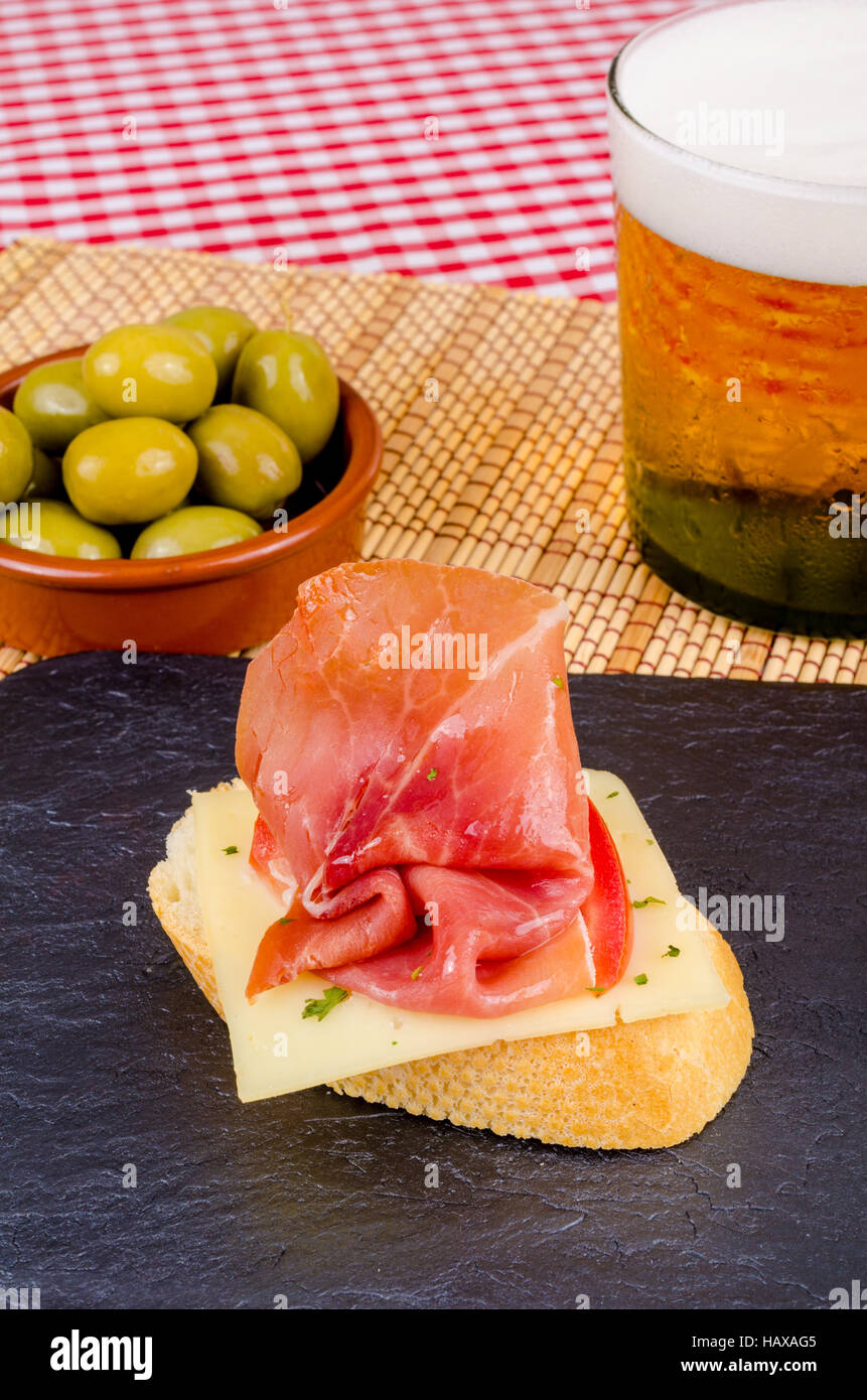 Traditional Spanish pincho style serrano ham tapa Stock Photo - Alamy