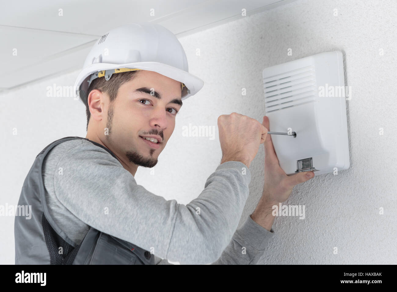 installing a device on the wall Stock Photo - Alamy