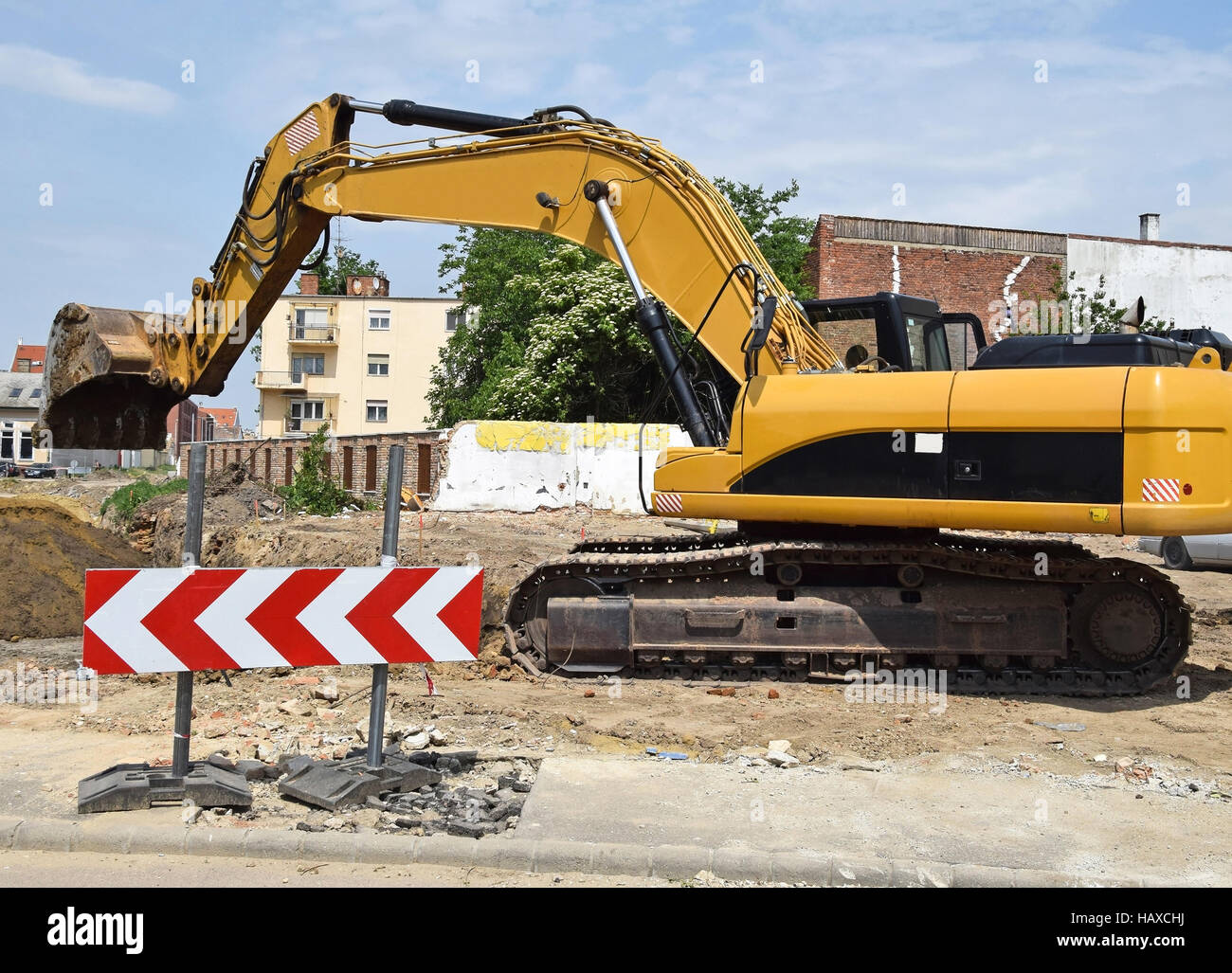 Excavator works at the road construction Stock Photo - Alamy