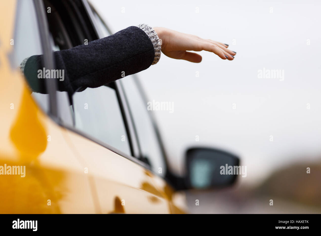 Girl extends hand from taxi Stock Photo - Alamy