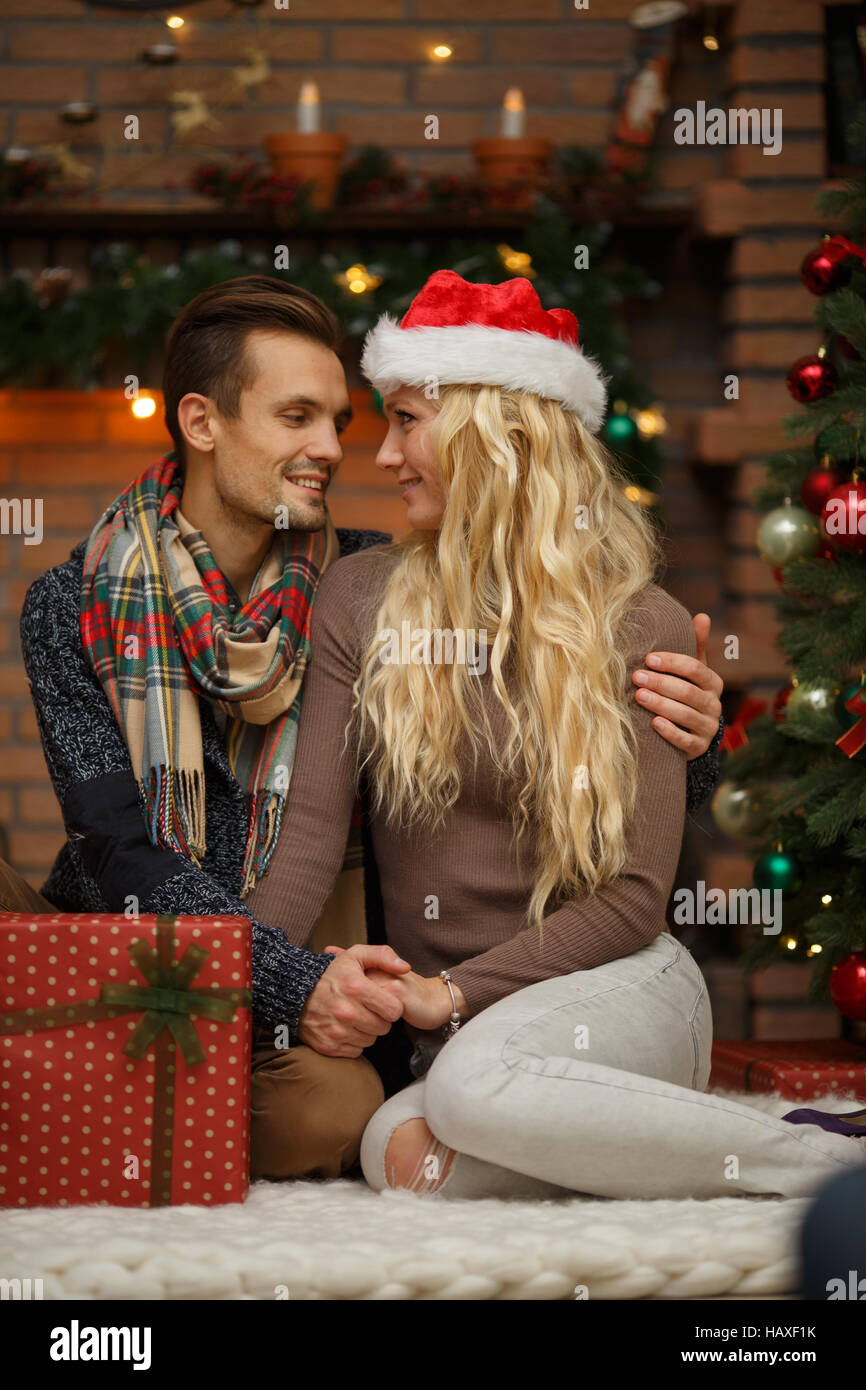 Loving family embracing against tree Stock Photo - Alamy