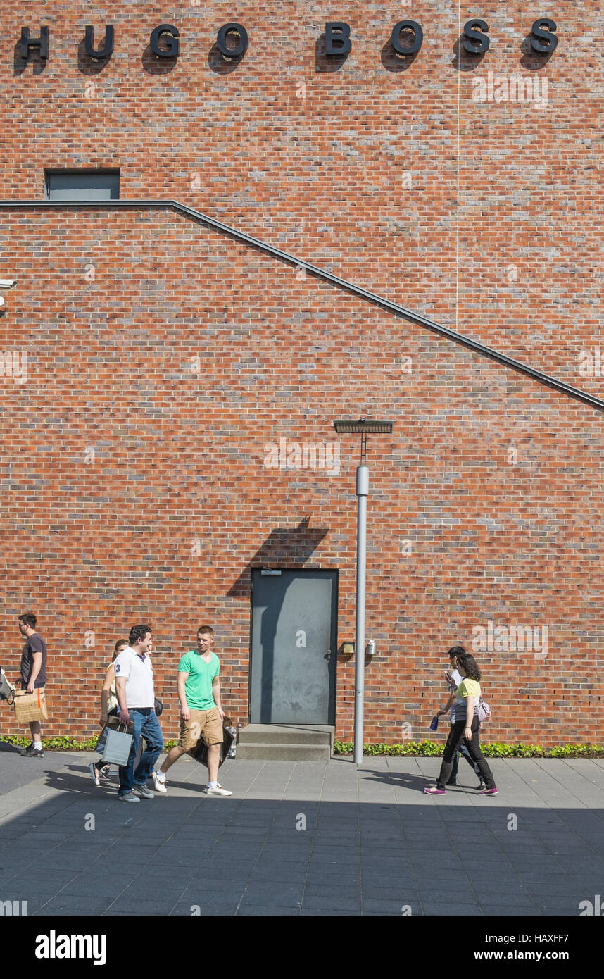 hugo boss outlet, shoppers, brick facade Stock Photo - Alamy