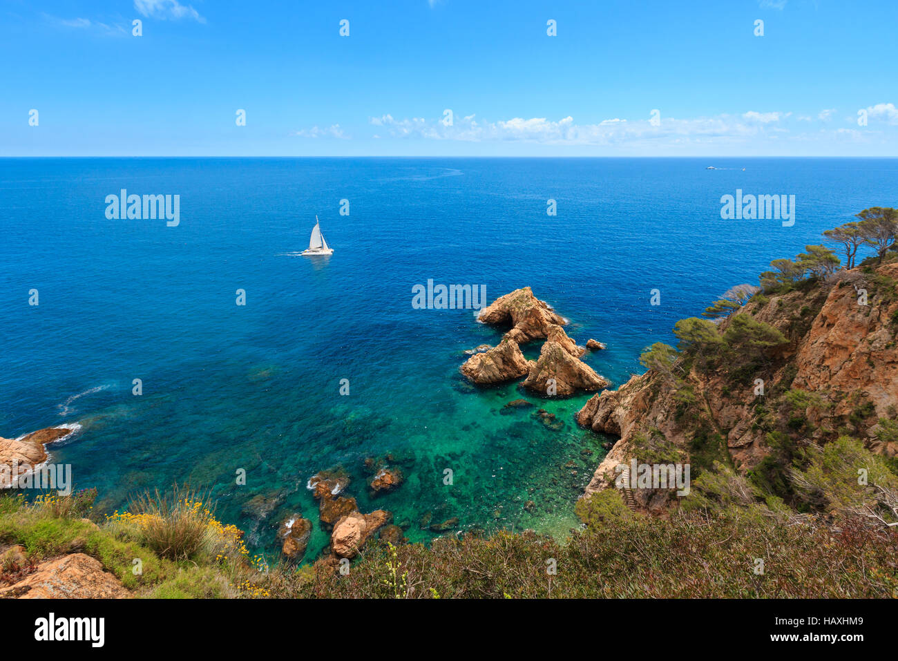 Summer sea rocky coast landscape with catamaran, Costa Brava, Spain ...