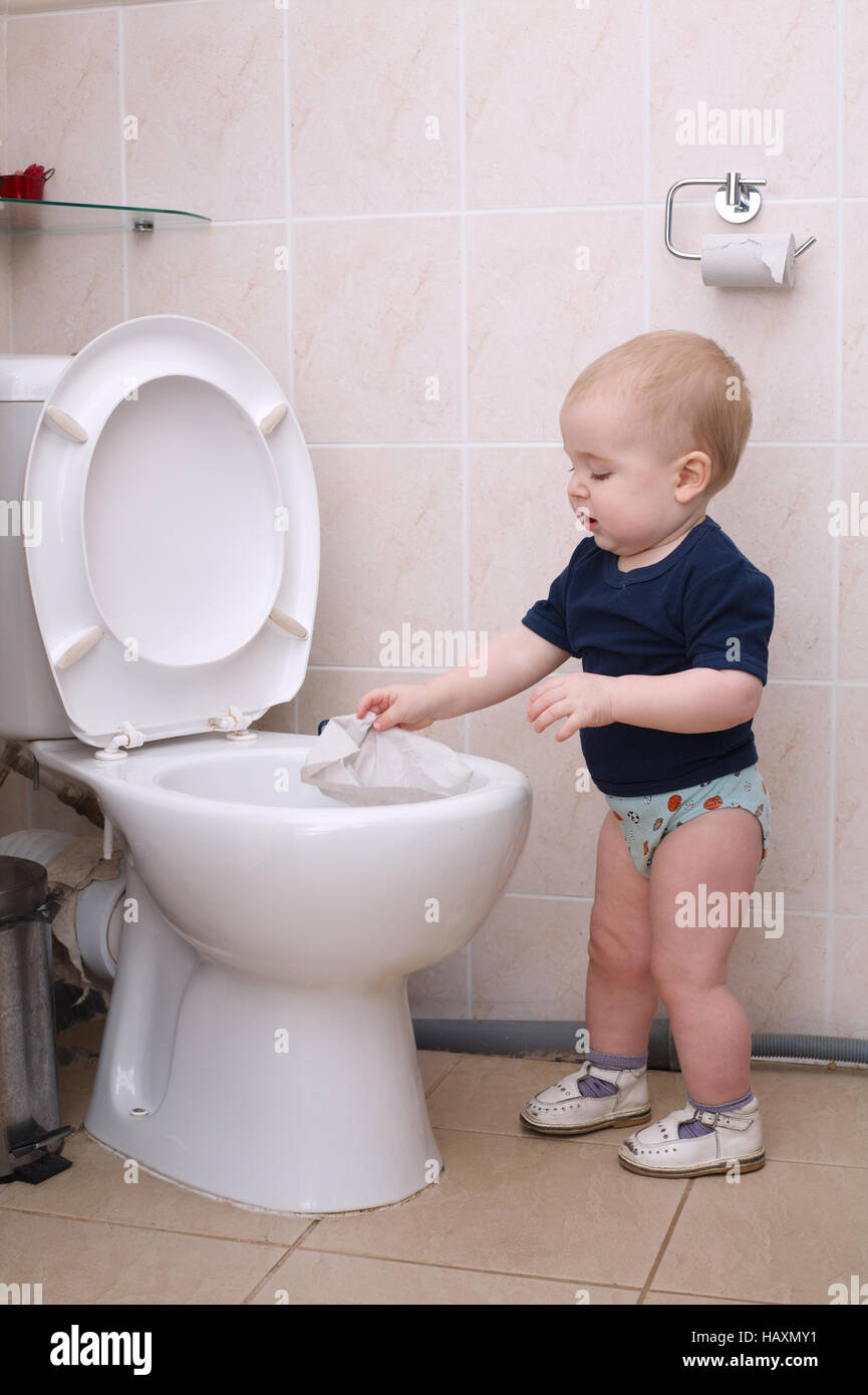 little boy looks in the toilet Stock Photo - Alamy