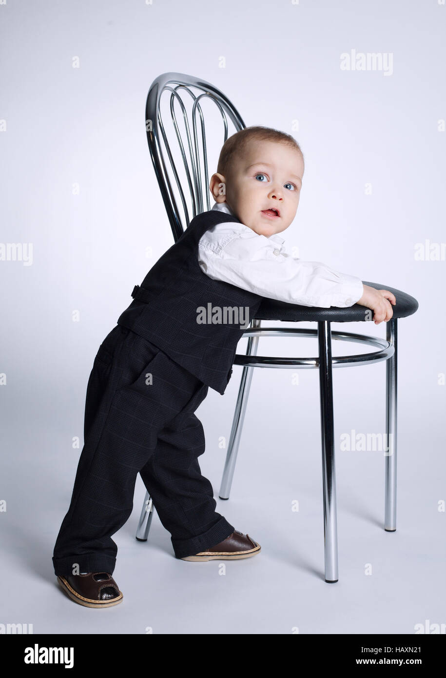 cute little boy with chair Stock Photo - Alamy