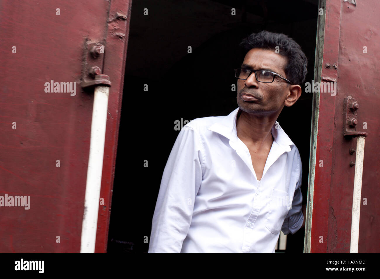Sri Lankan man on train Stock Photo - Alamy