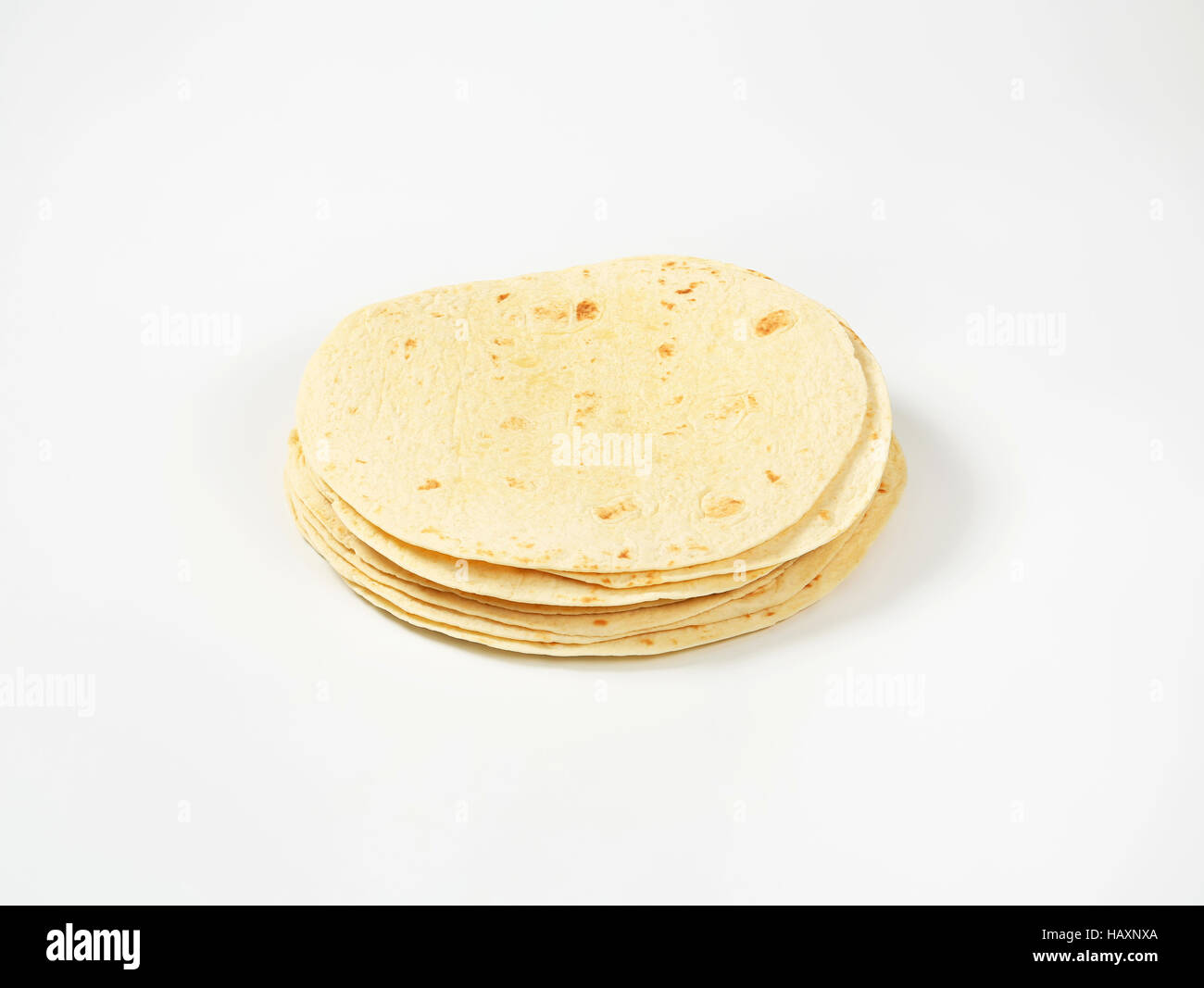 A stack of homemade tortillas on white background Stock Photo - Alamy