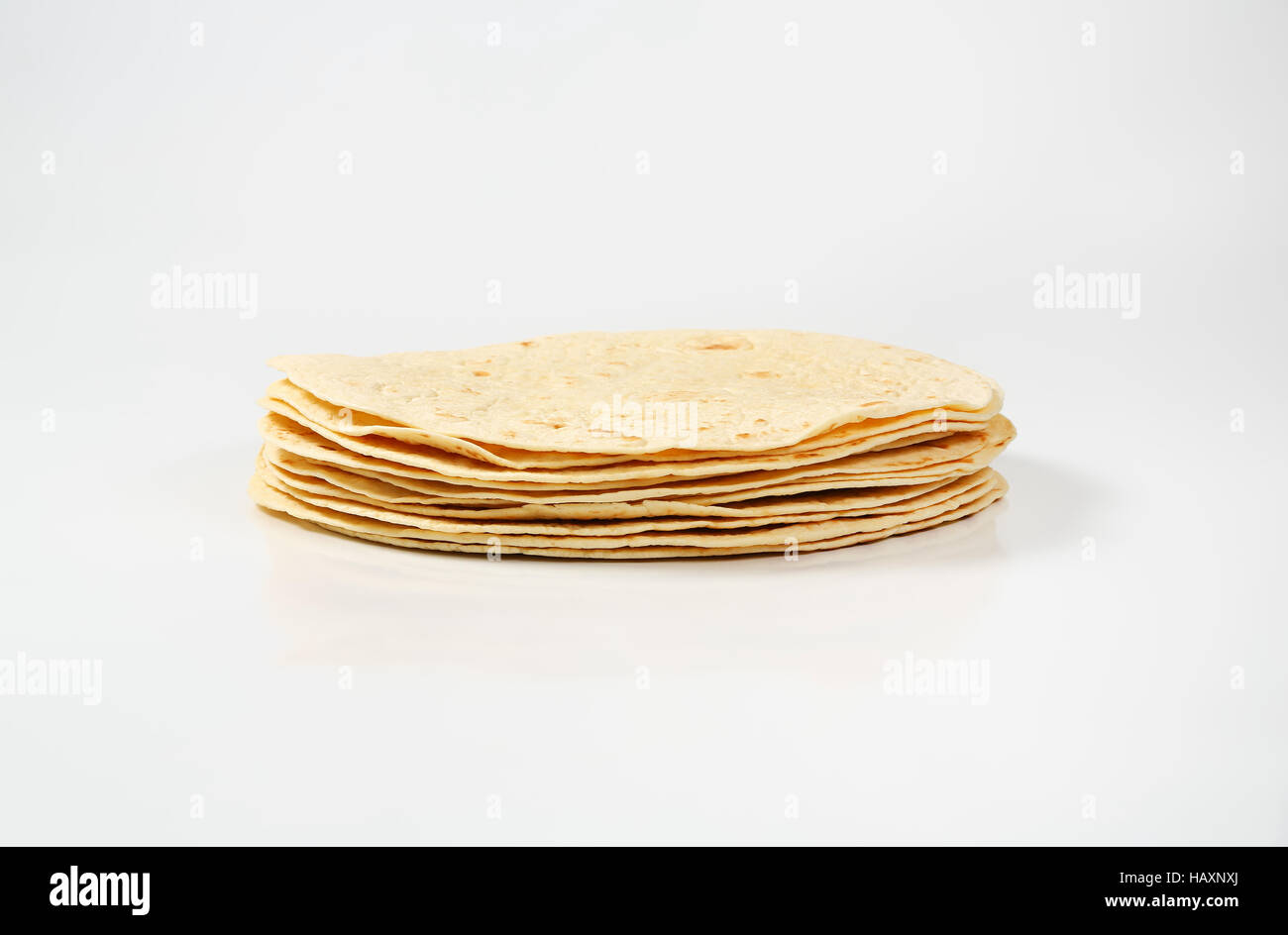 A stack of homemade tortillas on white background Stock Photo - Alamy