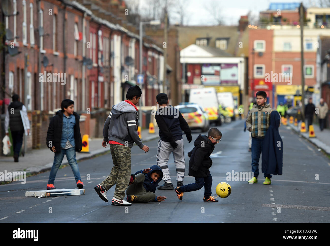 Children play football in the street before the Emirates FA Cup, Second ...