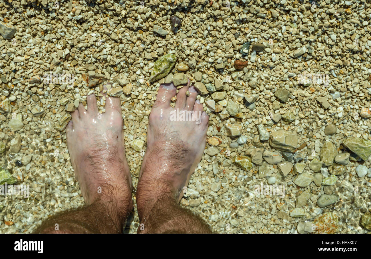 Foot in the shallow water Stock Photo - Alamy