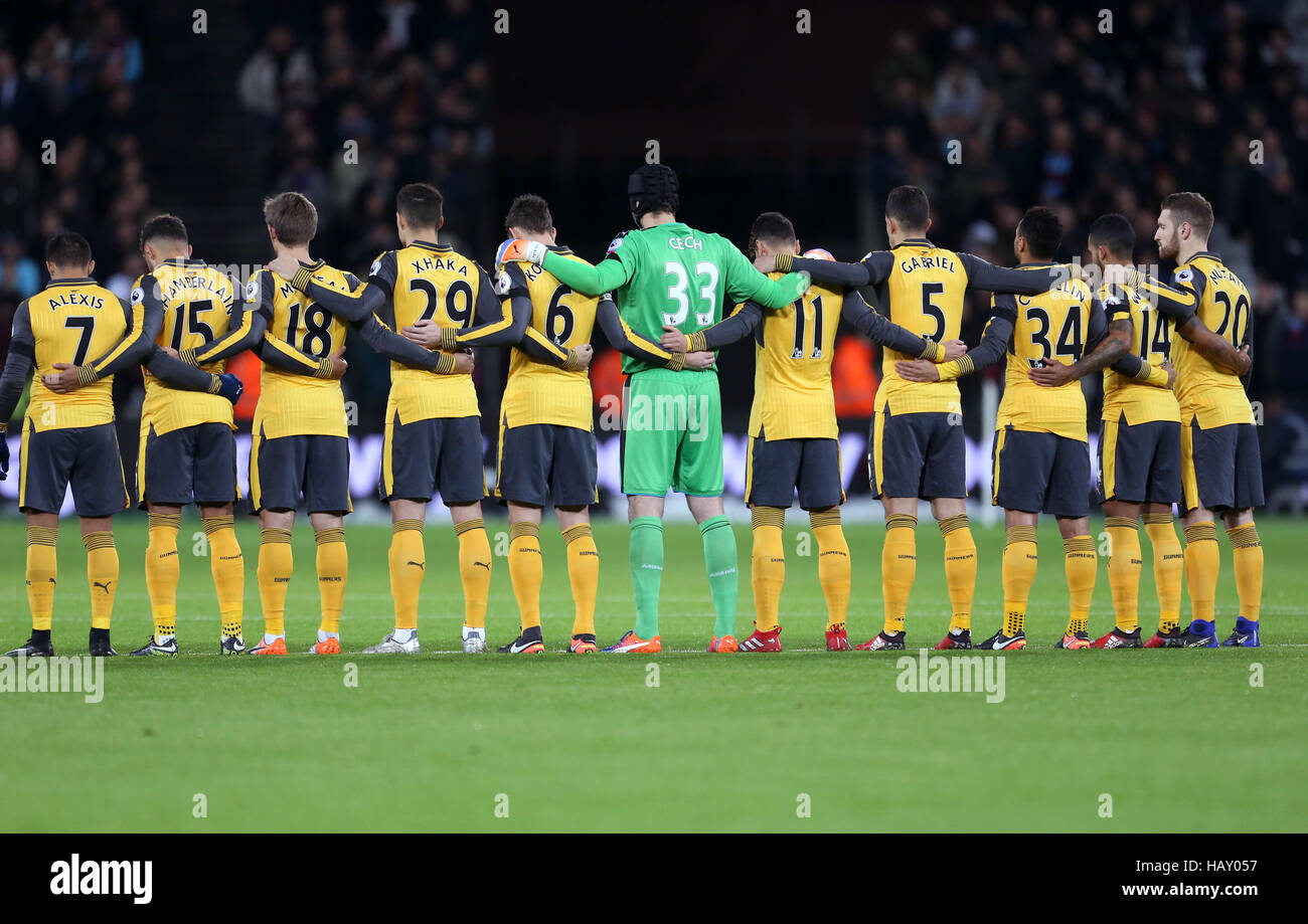 Arsenal players observe a minutes silence in memory of the victims of ...