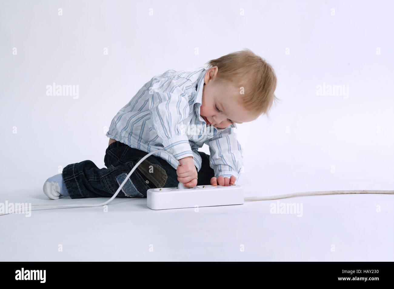little boy plays with plug Stock Photo - Alamy