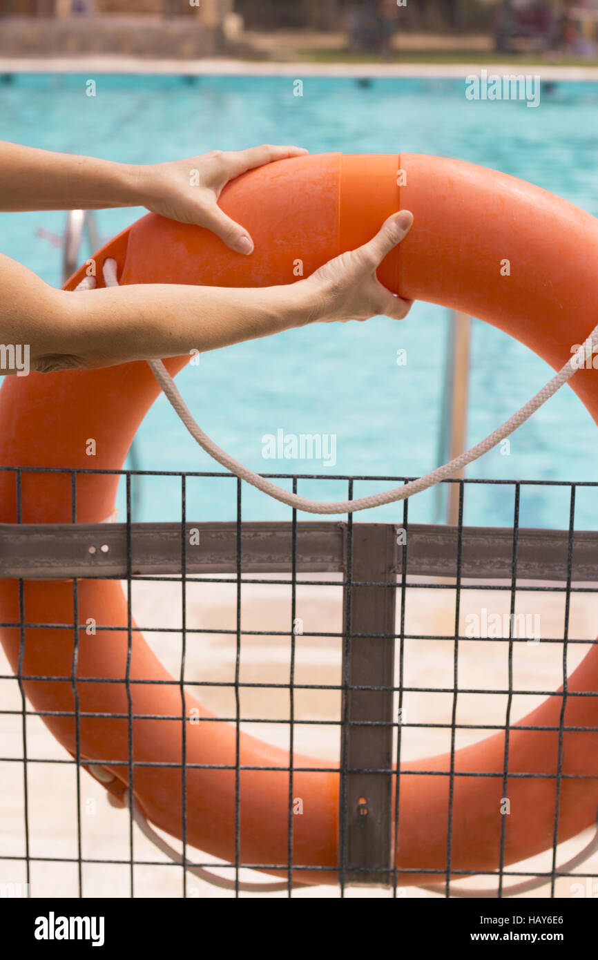 Woman catching lifeguard float in orange color Stock Photo - Alamy