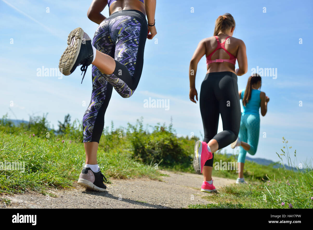 Three Female Joggers running together outdoors Stock Photo - Alamy