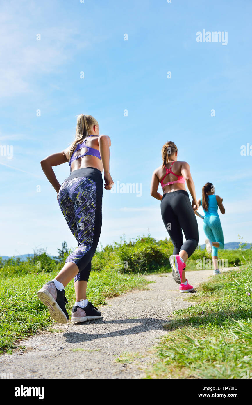 Three Female Joggers running together outdoors Stock Photo - Alamy