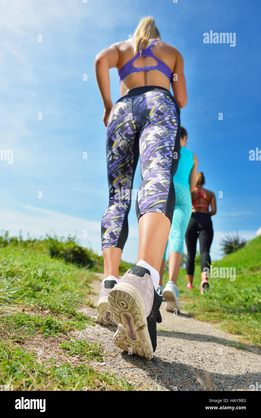 Three Female Joggers running together outdoors Stock Photo - Alamy