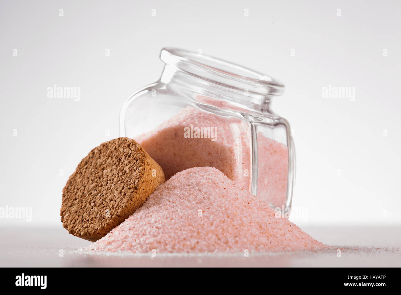 pink Himalayan salt in glass jar on white background Stock Photo - Alamy