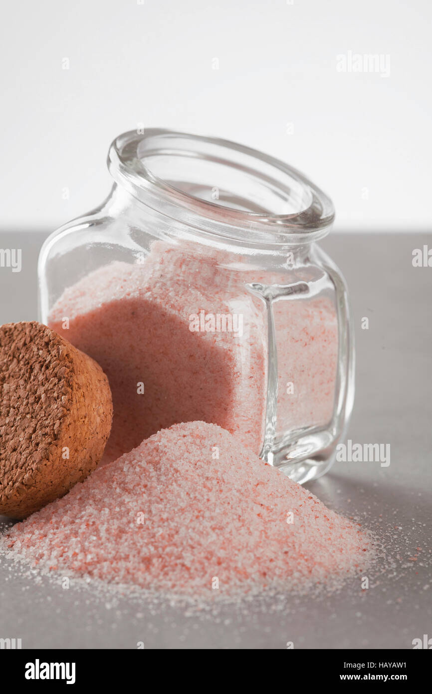 pink Himalayan salt in glass jar on gray and white background Stock ...