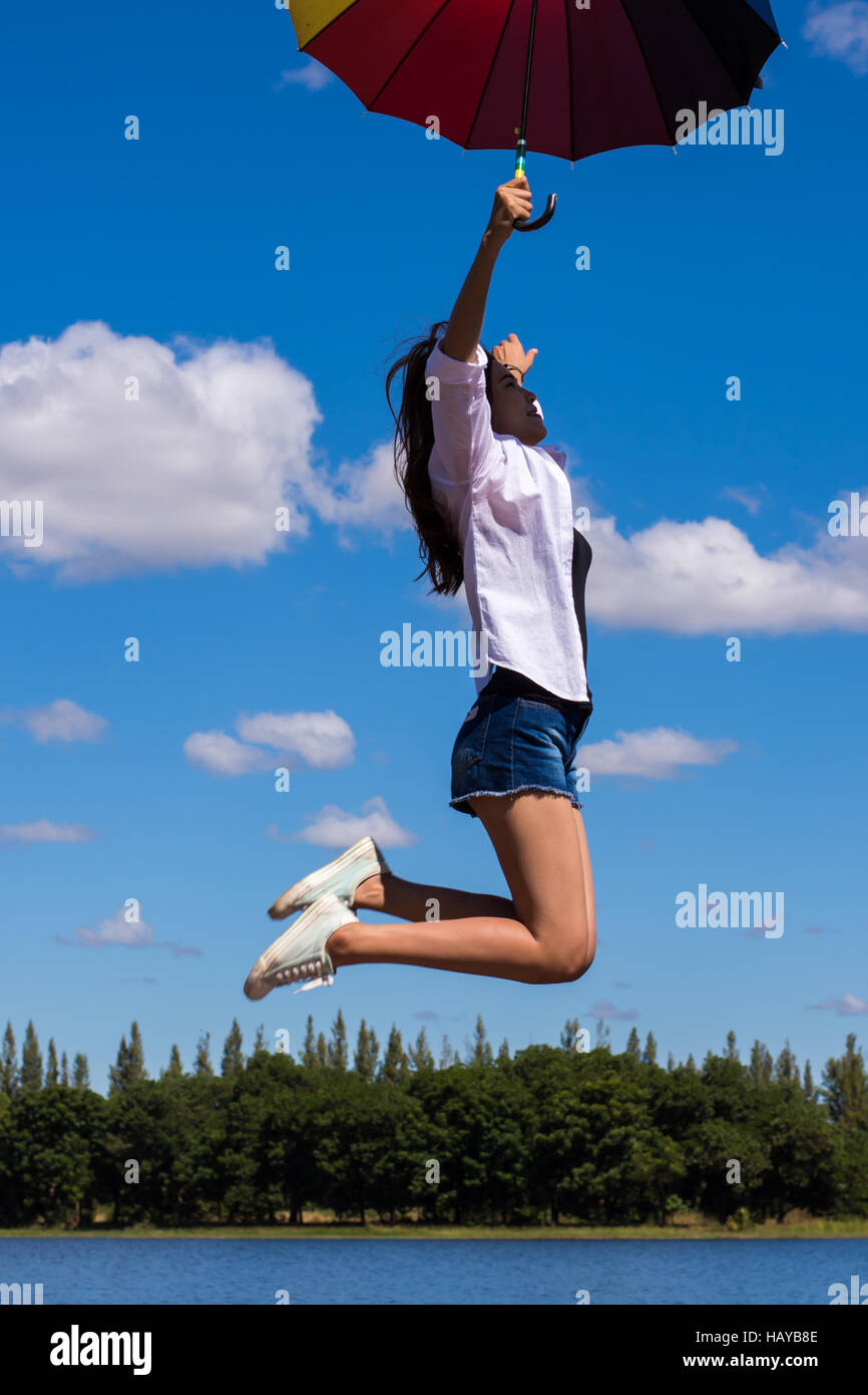 Happy girl jumping blue sky hi-res stock photography and images - Alamy