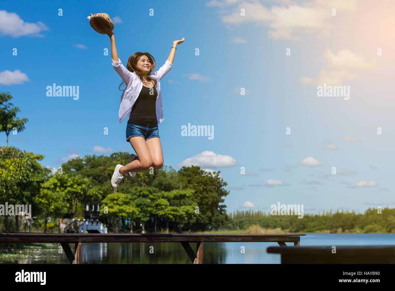 Young woman jumping joy on hi-res stock photography and images - Alamy