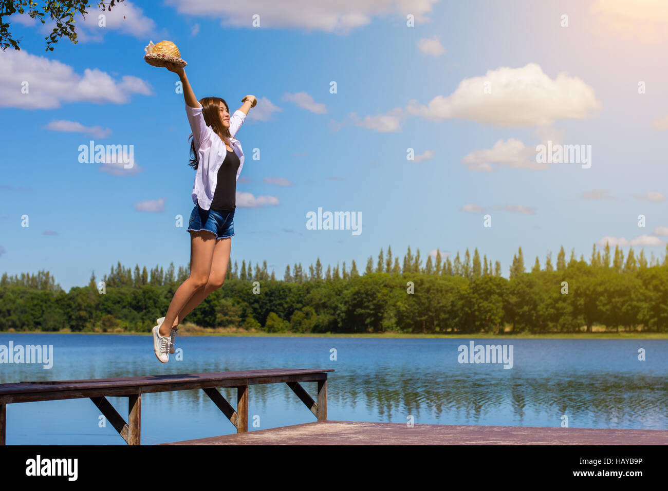 Happy girl jumping blue sky hi-res stock photography and images - Alamy