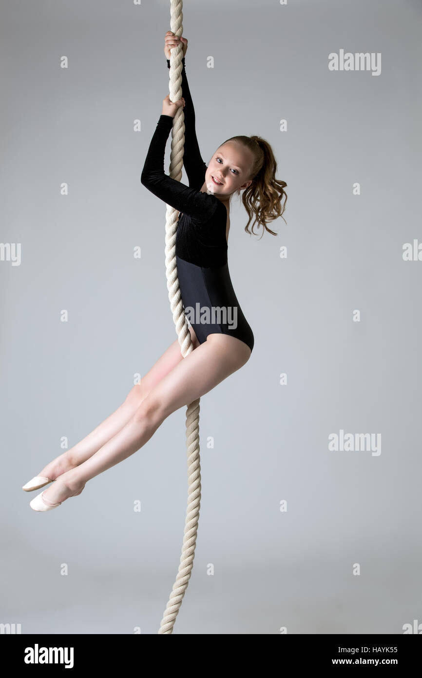 Charming little power gymnast climbs on rope Stock Photo - Alamy