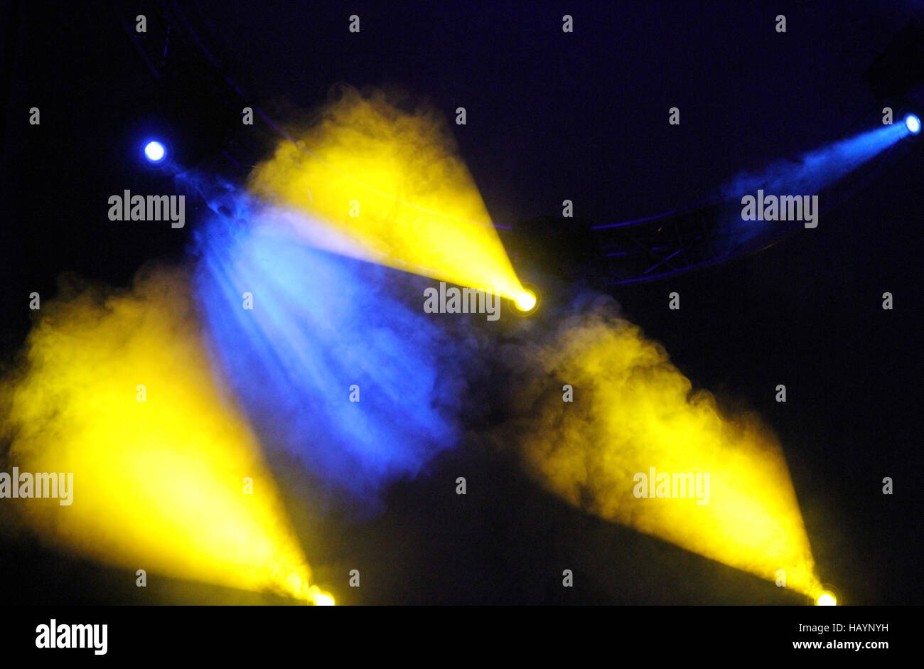 Blue and yellow colored light show over concert stage Stock Photo - Alamy