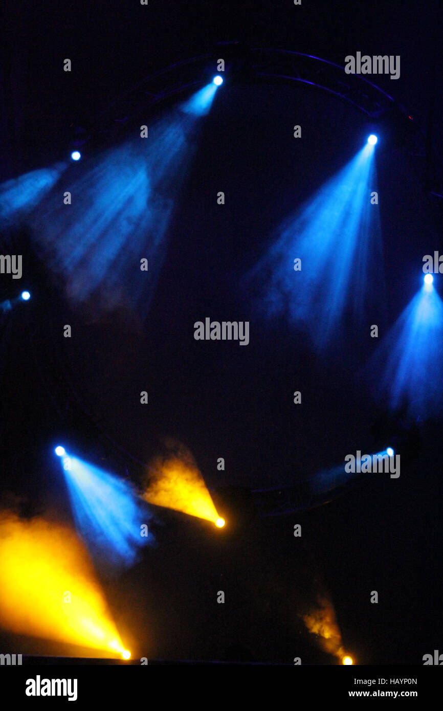 Blue and yellow colored light show over concert stage Stock Photo - Alamy