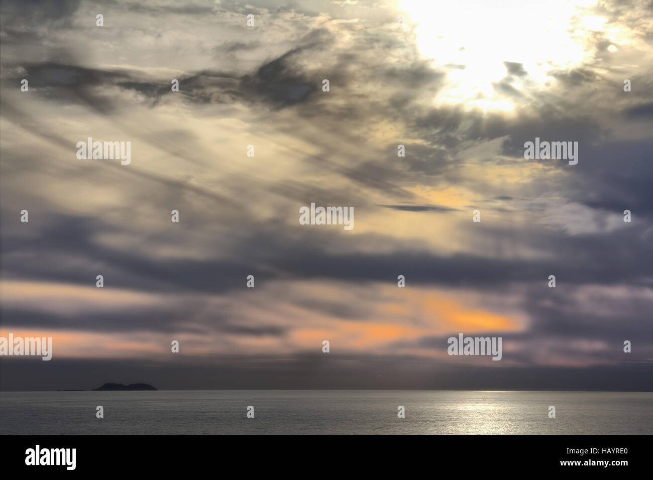 Bright rays of sun breaks through clouds over ocean expanse. Pacific ...