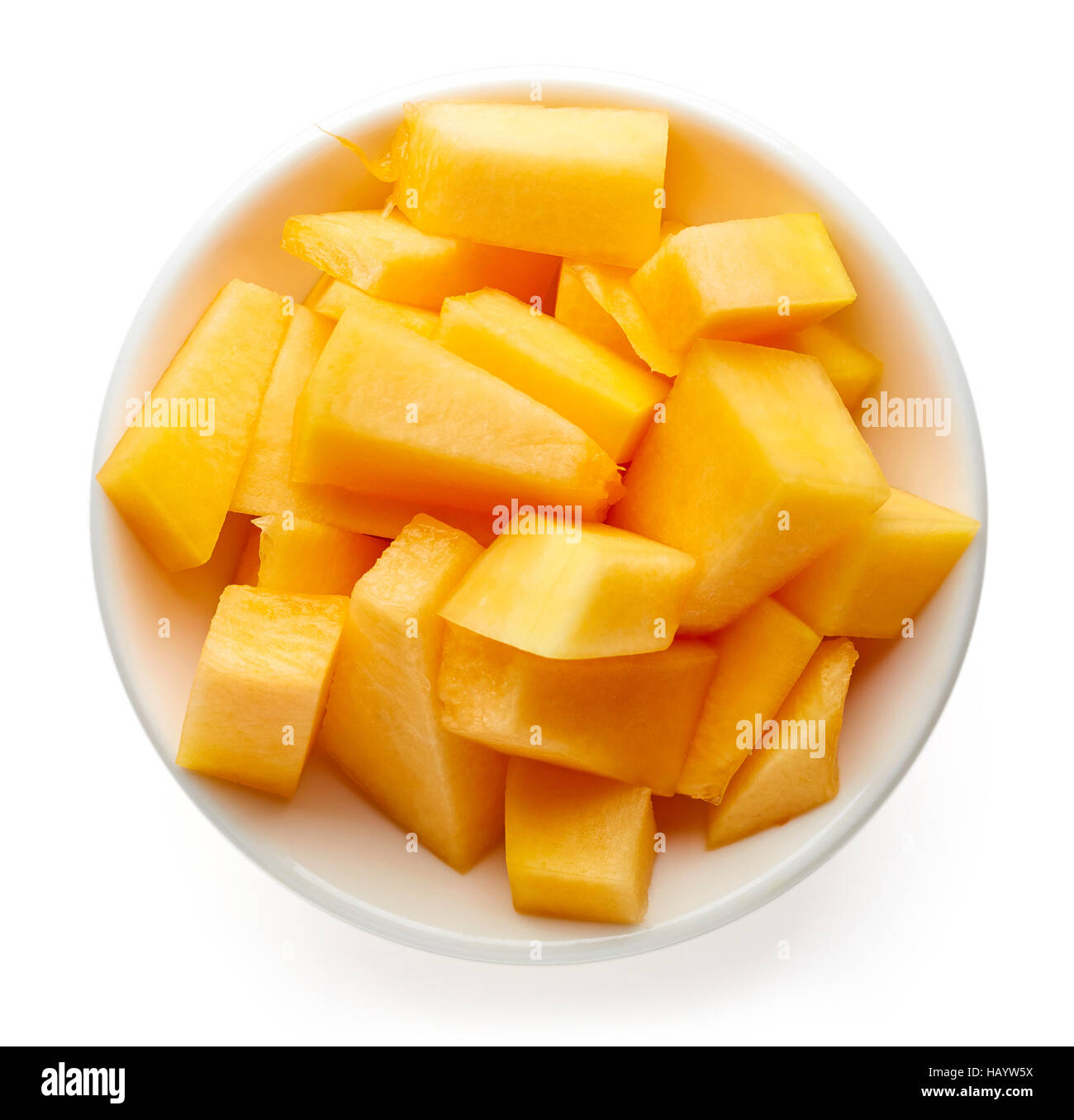 Bowl of pumpkin pieces isolated on white background, top view Stock ...