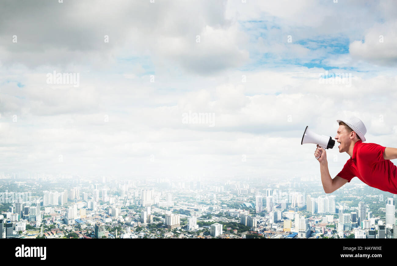 Guy screaming in loudspeaker Stock Photo - Alamy