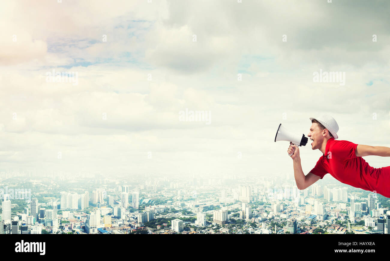 Guy screaming in loudspeaker Stock Photo - Alamy