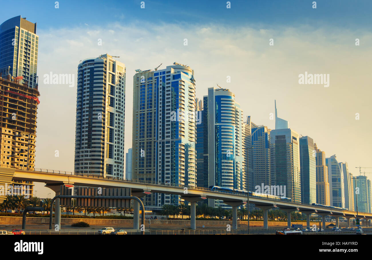 Metro line going through Dubai Marina with modern skyscrapers around ...