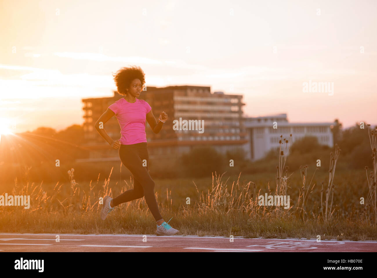 young beautiful African American woman enjoys running outside beautiful ...