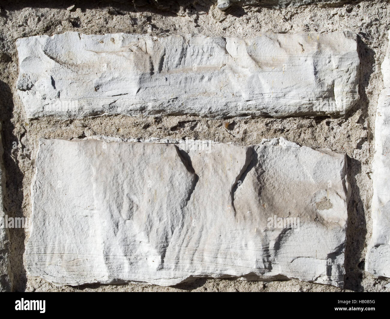 two lime stones one above the other Stock Photo - Alamy